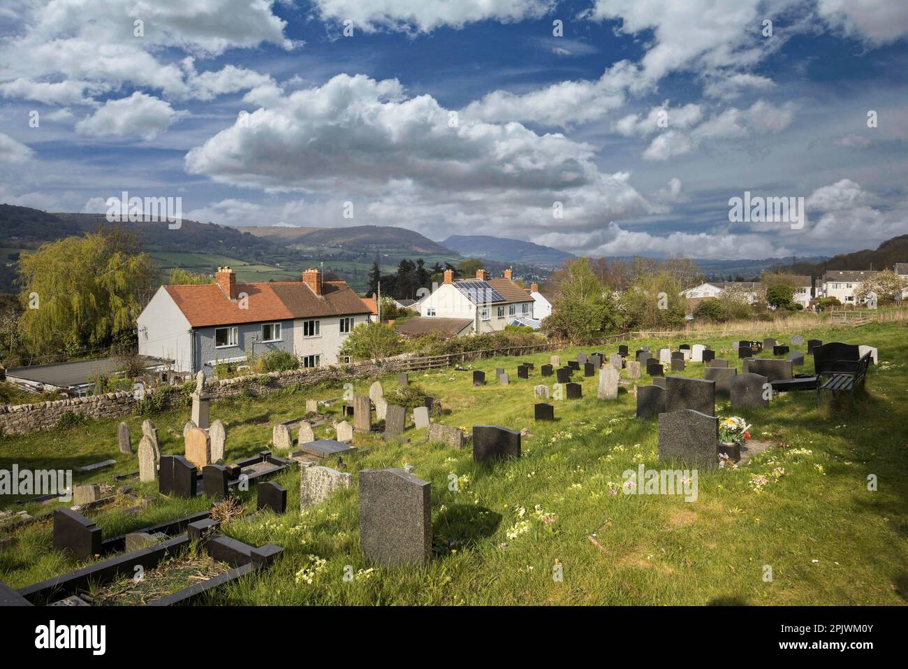 Graveyard with headstones and spring flowers in village, Govilon, Wales ...