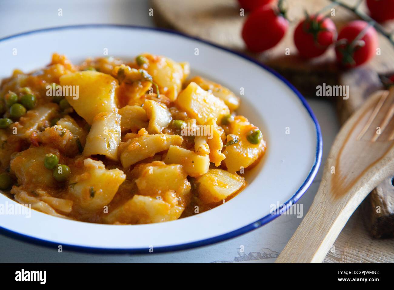 Stewed cuttlefish with potatoes. Traditional Spanish tapa recipe Stock ...