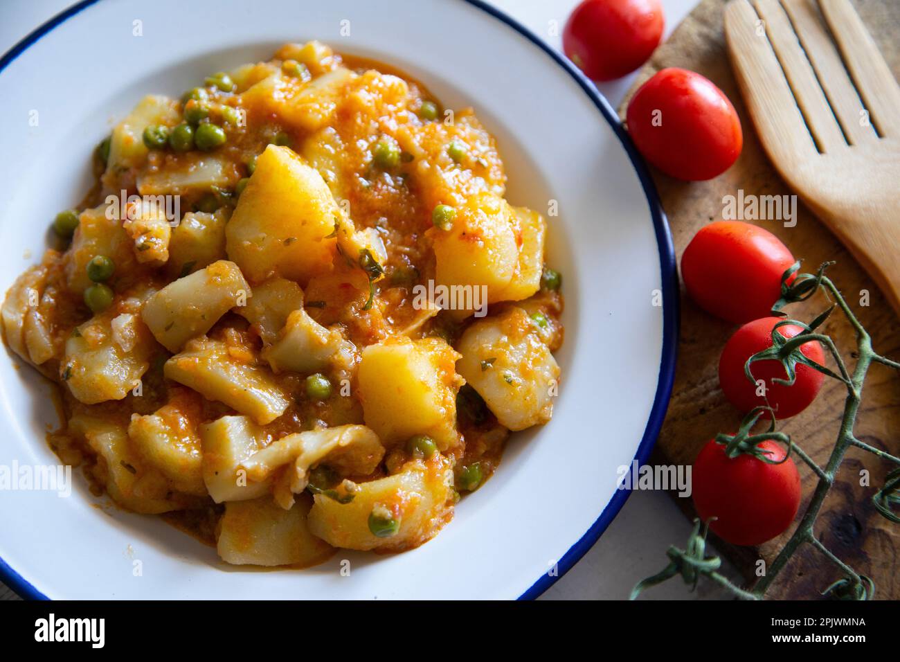 Stewed cuttlefish with potatoes. Traditional Spanish tapa recipe Stock ...