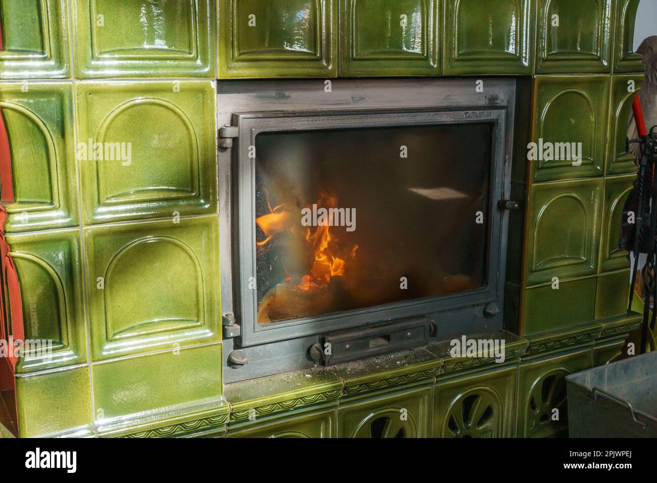 a fireplace and a tiled stove Stock Photo - Alamy