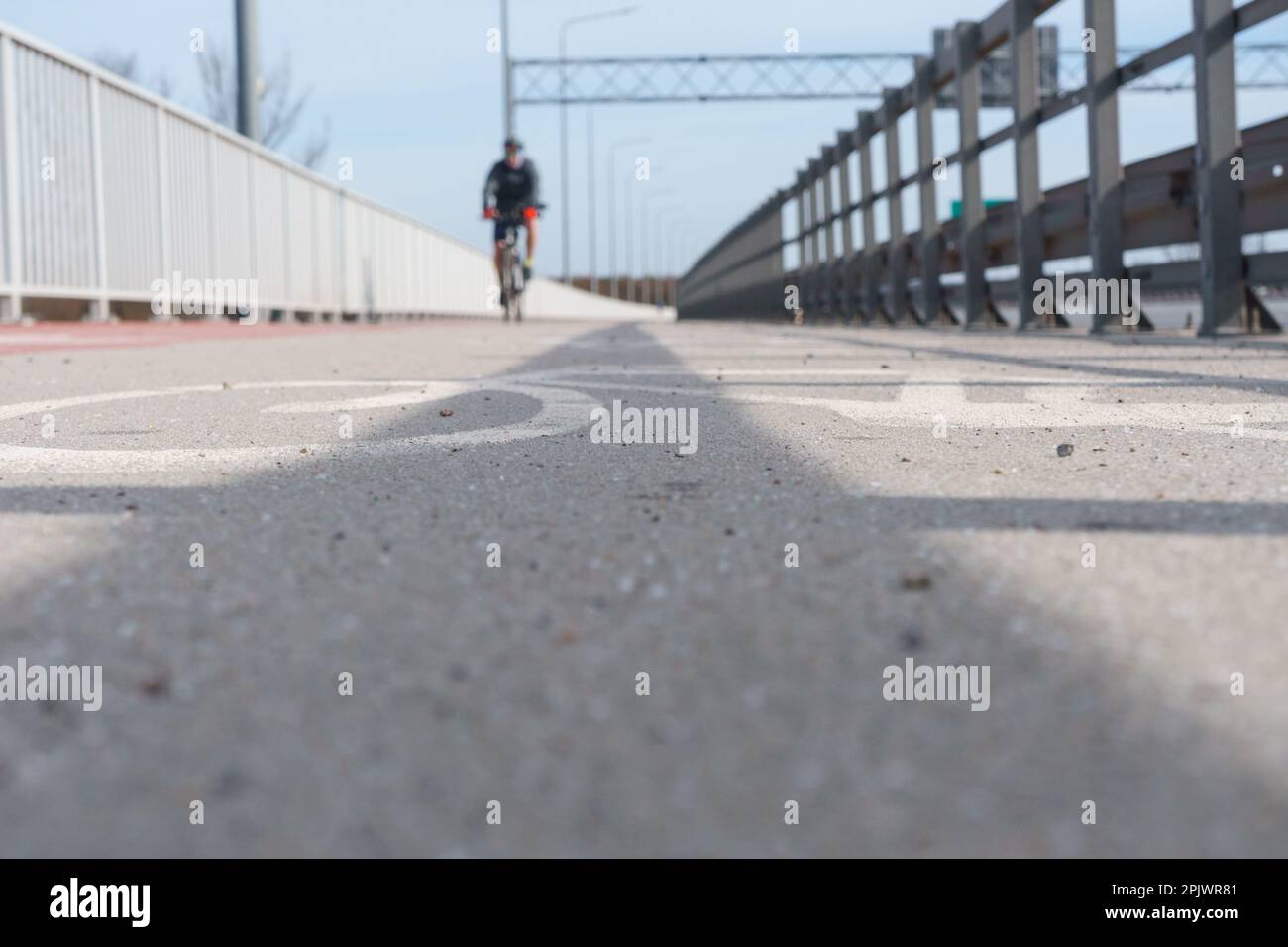 a bicycle path on South Bridge in Warsaw, Poland, with a cyclist ...