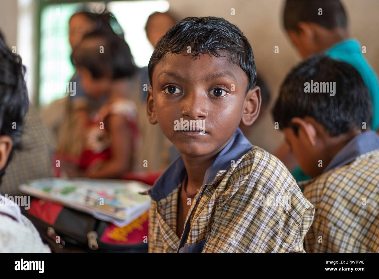 School boy looking at camera in classroom Stock Photo - Alamy