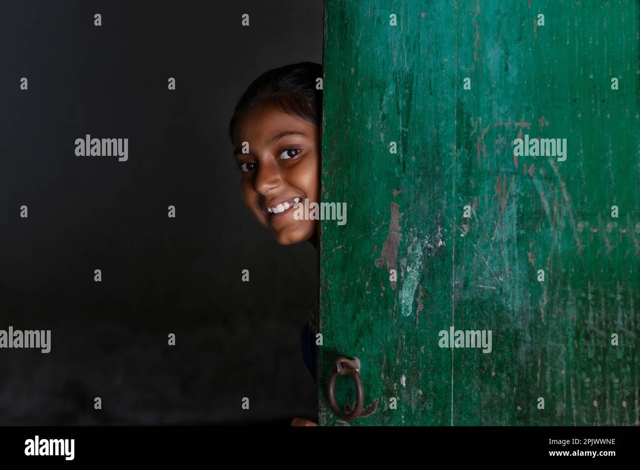 School girl peeping from a classroom Stock Photo - Alamy