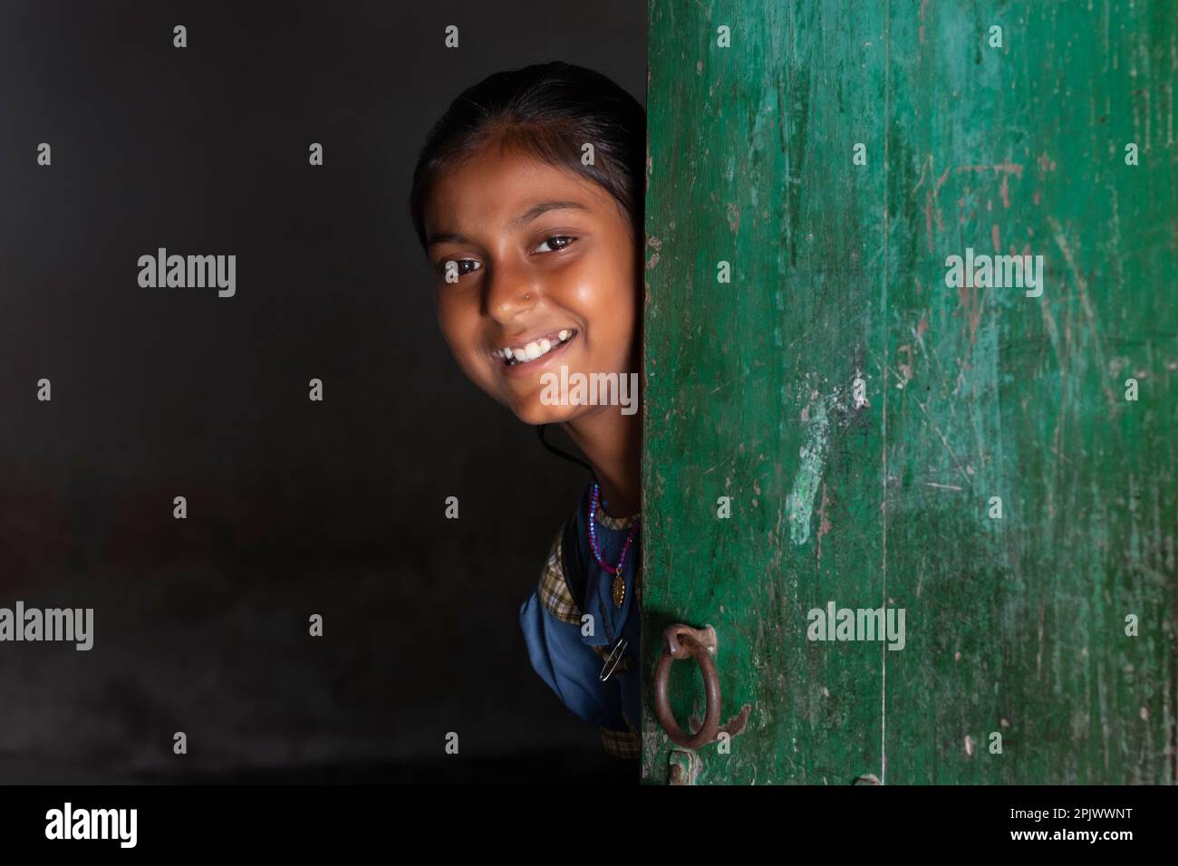 School girl peeping from a classroom Stock Photo - Alamy