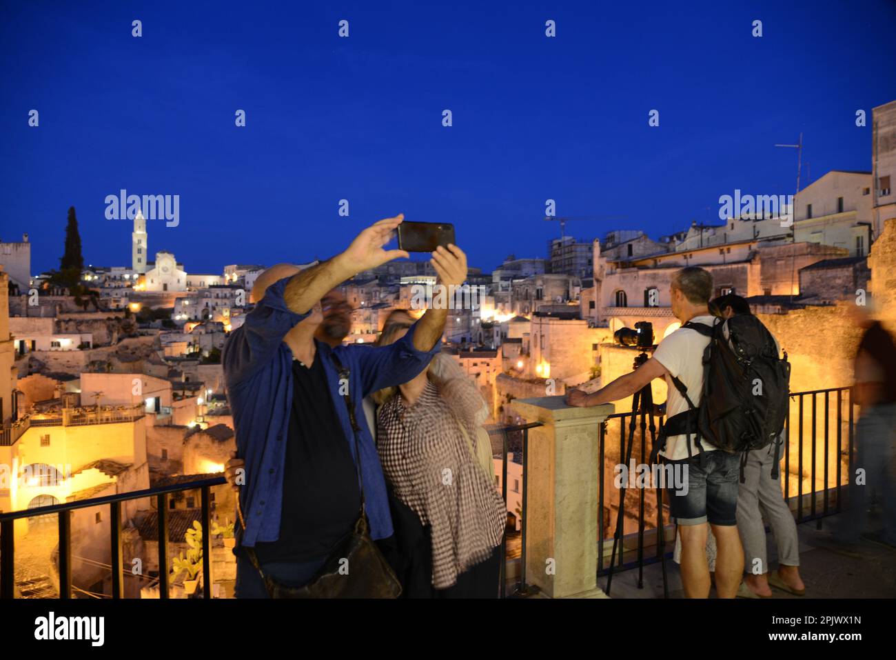 Tourist taking pictures and selfies. At night with suggestive lights ...