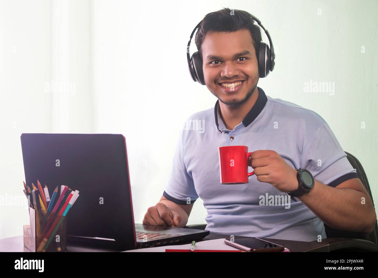 Teenage boy drinking coffee during study at home Stock Photo - Alamy