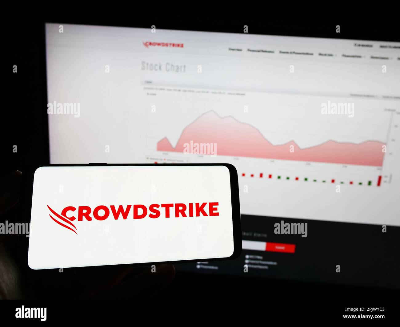 Person holding mobile phone with logo of cybersecurity company ...