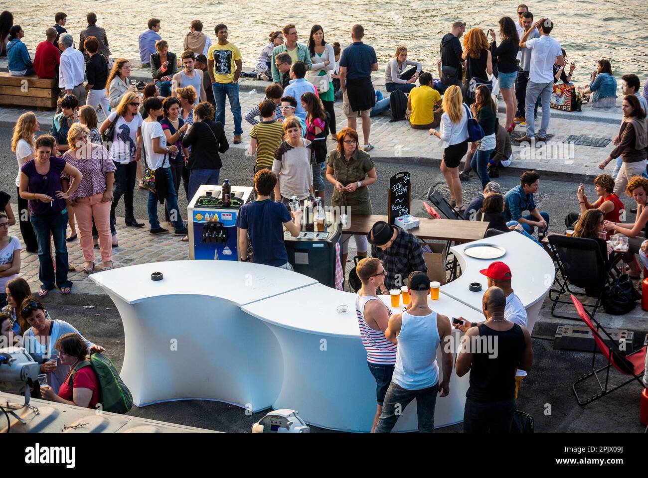 Paris, France, Large Crowd Picnicking, Sharing Drinks on Seine River ...