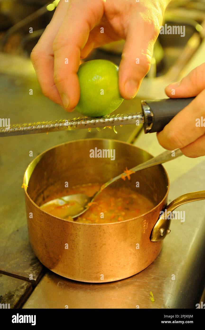 Preparation of a traditional risotto in a professional kitchen, Italy ...