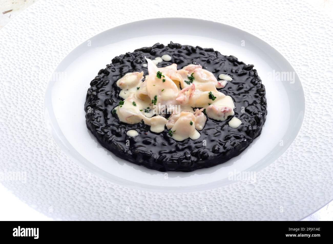 A dish of black Venere risotto with cuttlefish ink and boiled ...