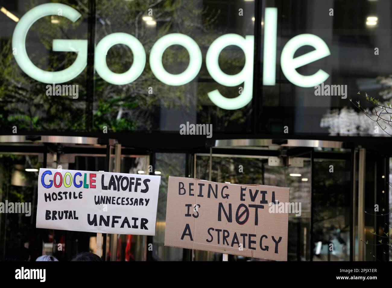 Google employees hold signs during a protest outside Google ...