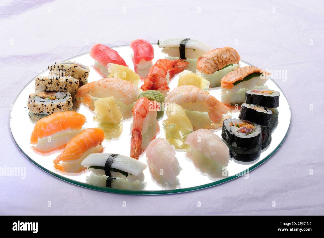 A tray with mixed japanese raw fish, seawood and rice; sushi; sashimi ...
