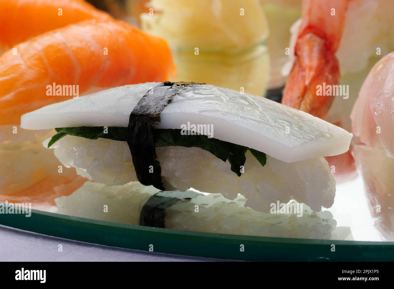 A tray with mixed japanese raw fish, seawood and rice; sushi; sashimi ...