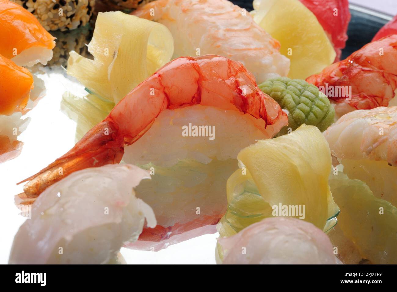 A tray with mixed japanese raw fish, seawood and rice; sushi; sashimi ...