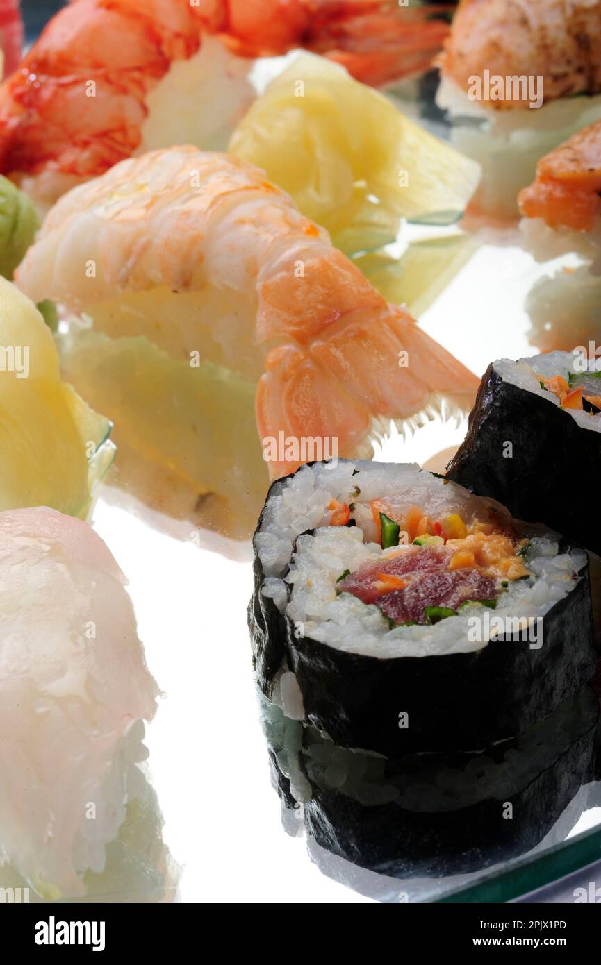 A tray with mixed japanese raw fish, seawood and rice; sushi; sashimi ...