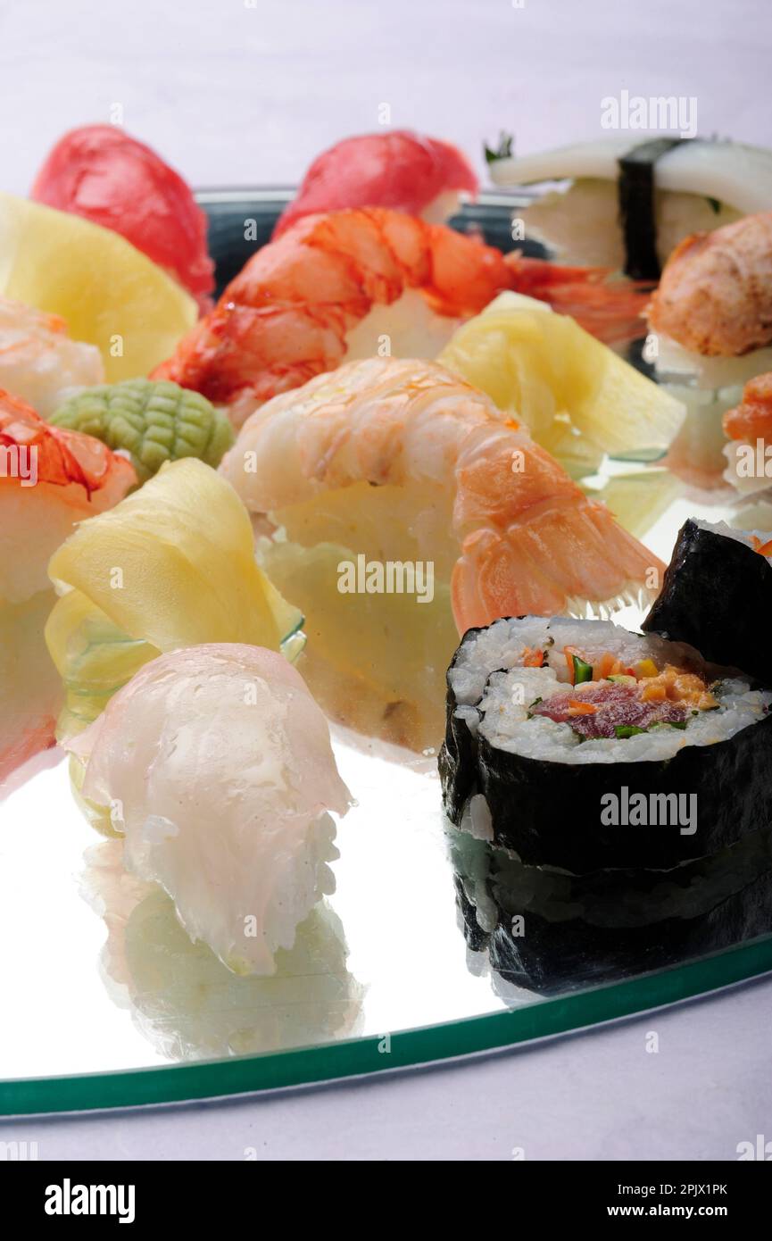 A tray with mixed japanese raw fish, seawood and rice; sushi; sashimi ...