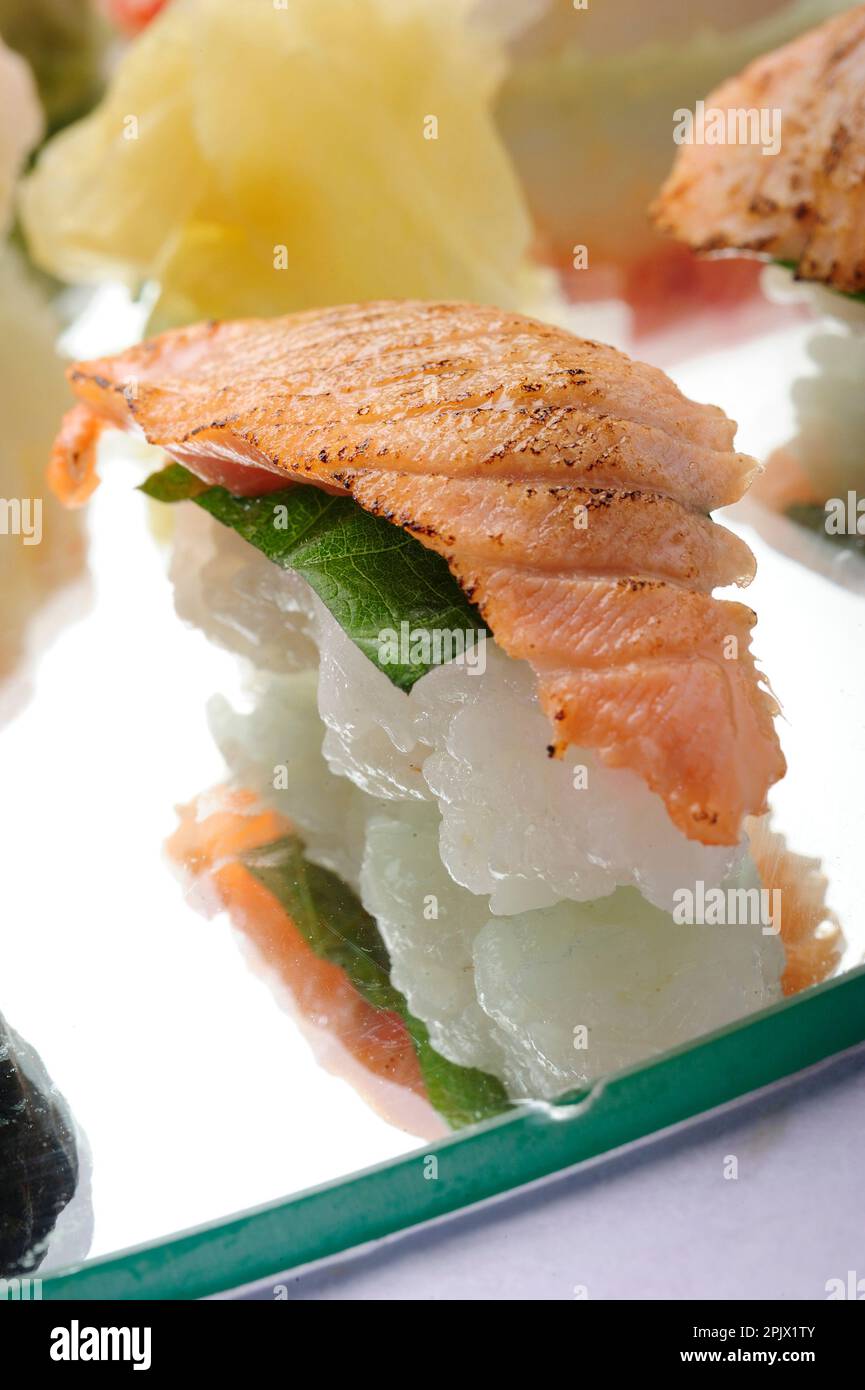 A tray with mixed japanese raw fish, seawood and rice; sushi; sashimi ...