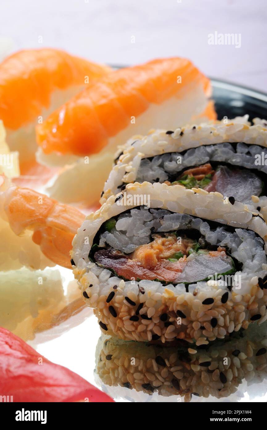 A tray with mixed japanese raw fish, seawood and rice; sushi; sashimi ...