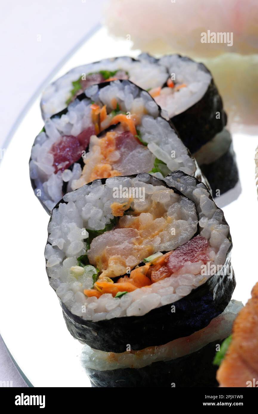 A tray with mixed japanese raw fish, seawood and rice; sushi; sashimi ...