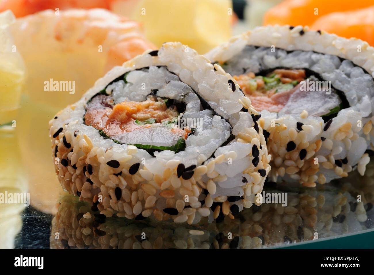A tray with mixed japanese raw fish, seawood and rice; sushi; sashimi ...