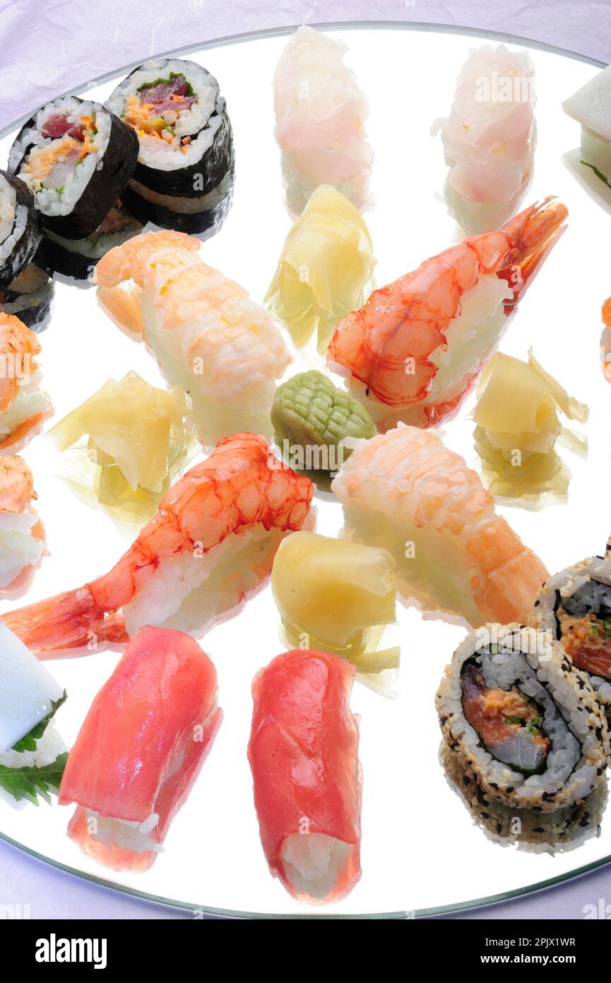 A tray with mixed japanese raw fish, seawood and rice; sushi; sashimi ...