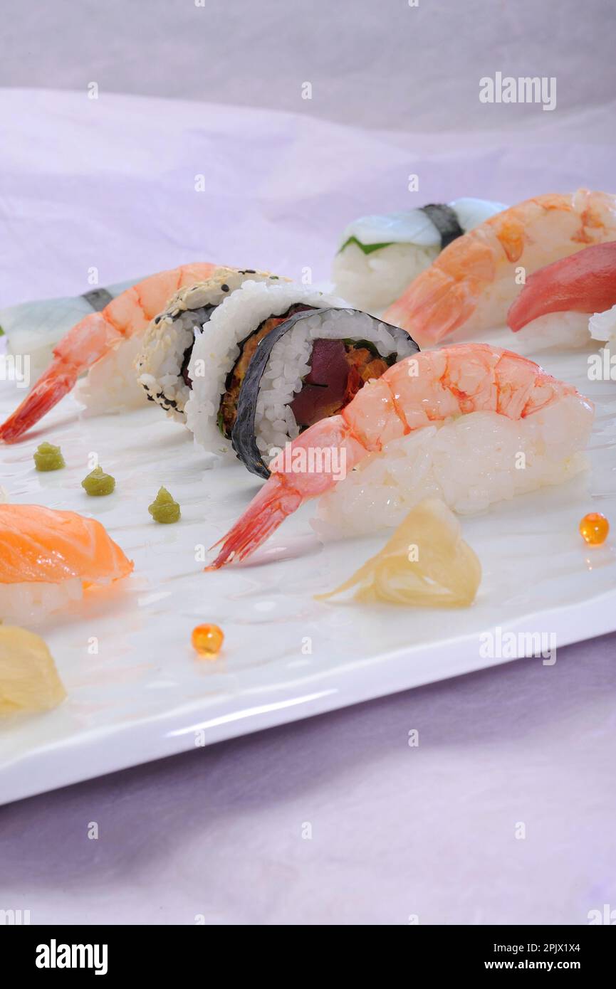 A tray with mixed japanese raw fish, seawood and rice; sushi; sashimi ...