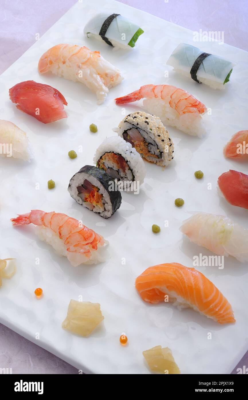 A tray with mixed japanese raw fish, seawood and rice; sushi; sashimi ...