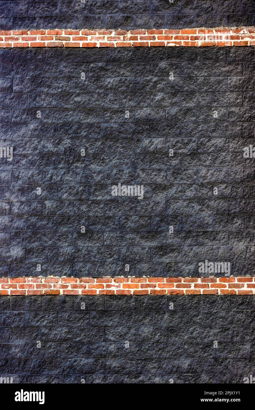 Close up of a charred color brick exterior wall of a building with rtwo ...