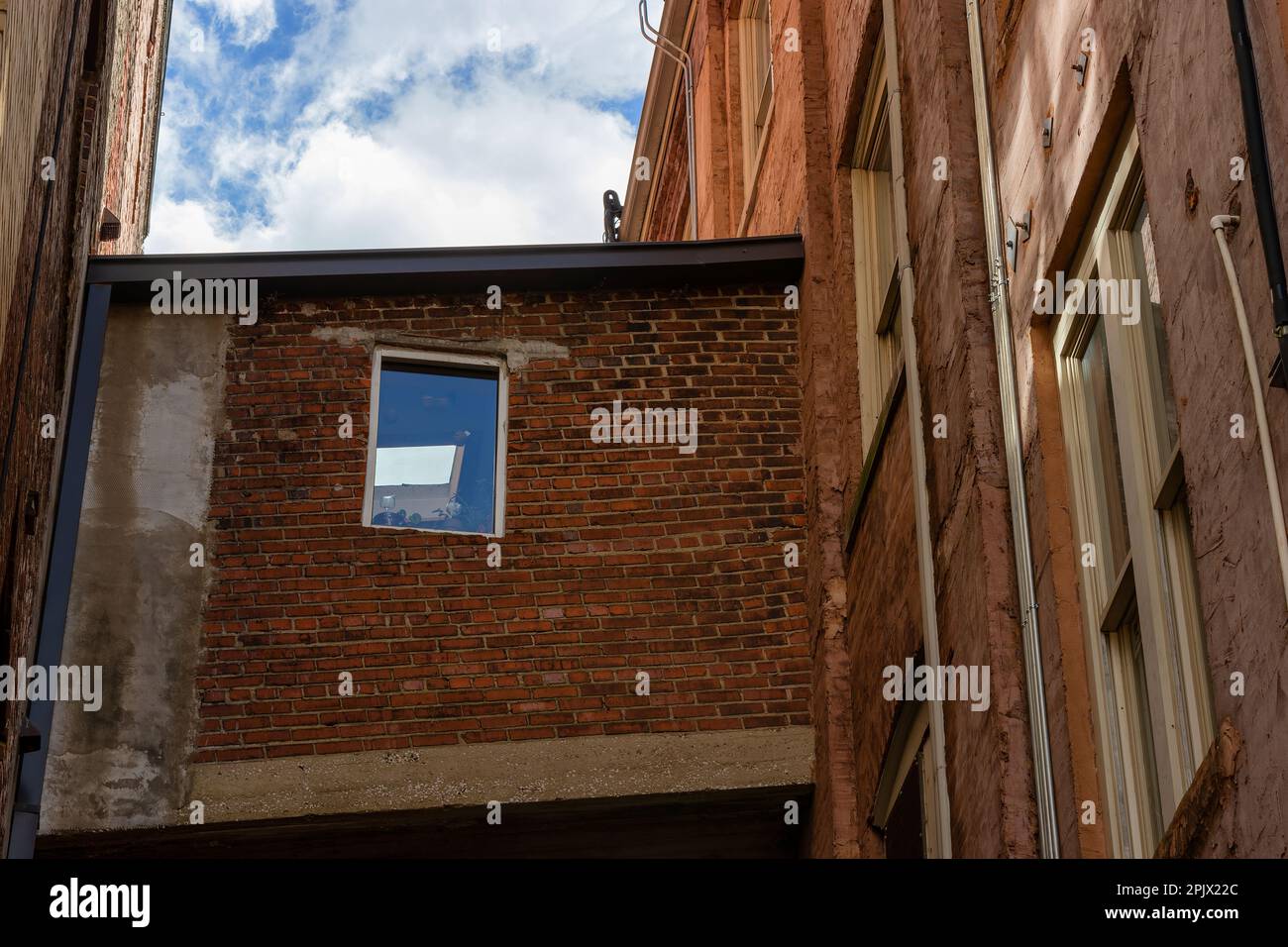 Brick structure that connects two buildings with a window and a ...