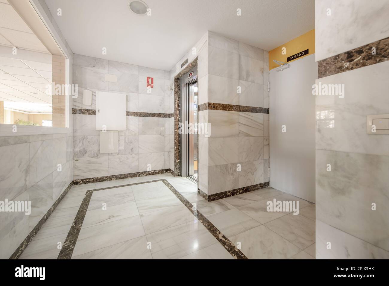 Interior portal of a residential building with white marble floors and ...