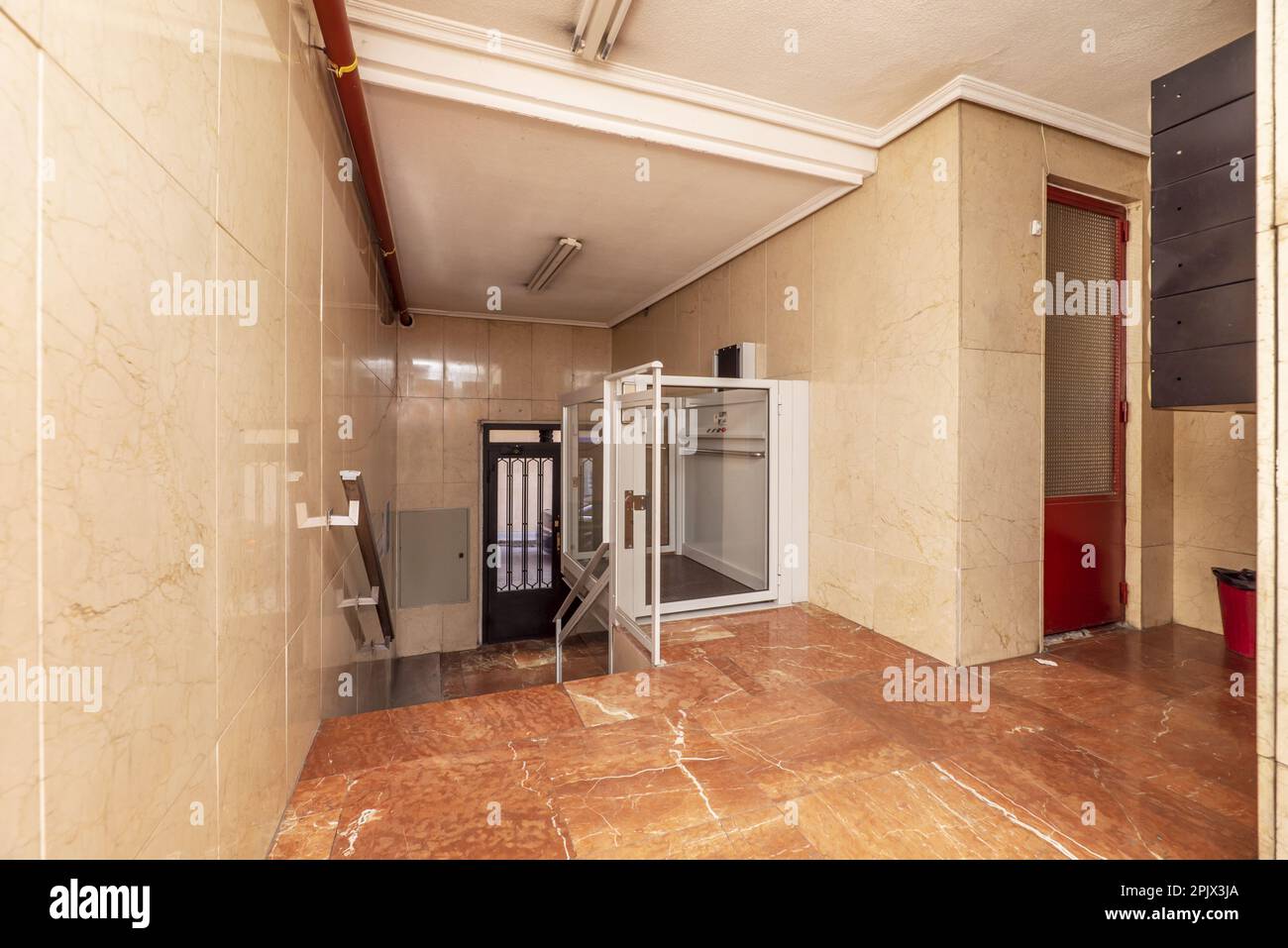 Access portal to a residential building with stairs and tiled floors of ...