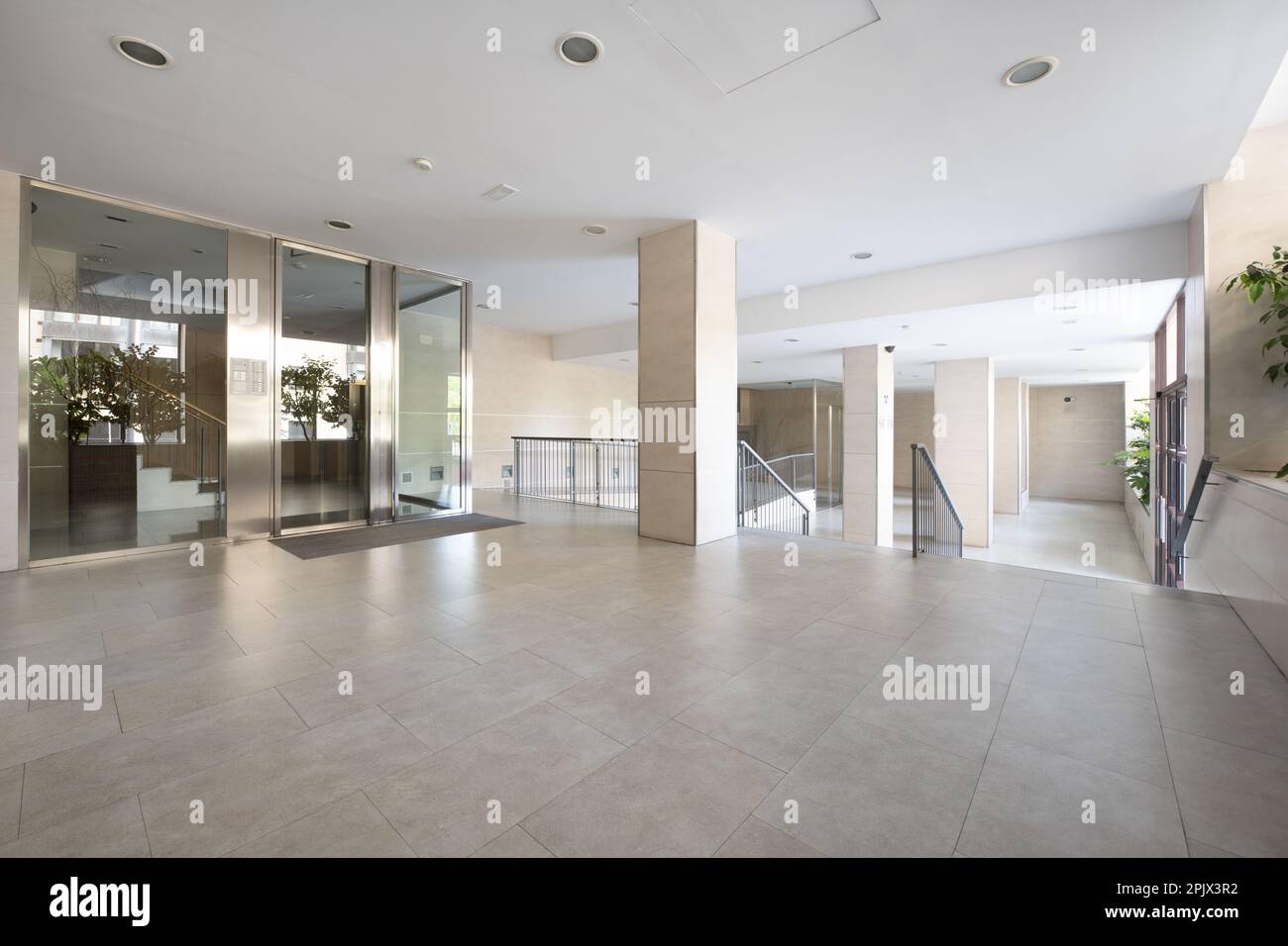Exterior street portal of a residential building with cream marble ...