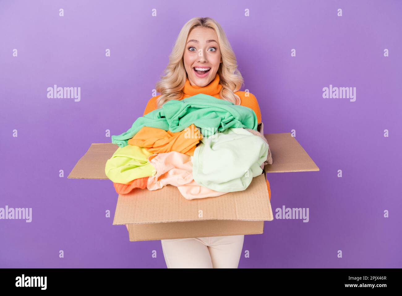Photo of astonished funky girl hold carton box pile stack clothes ...