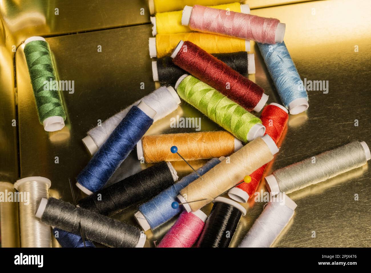A bunch of bulk thread spools on a metal can Stock Photo - Alamy