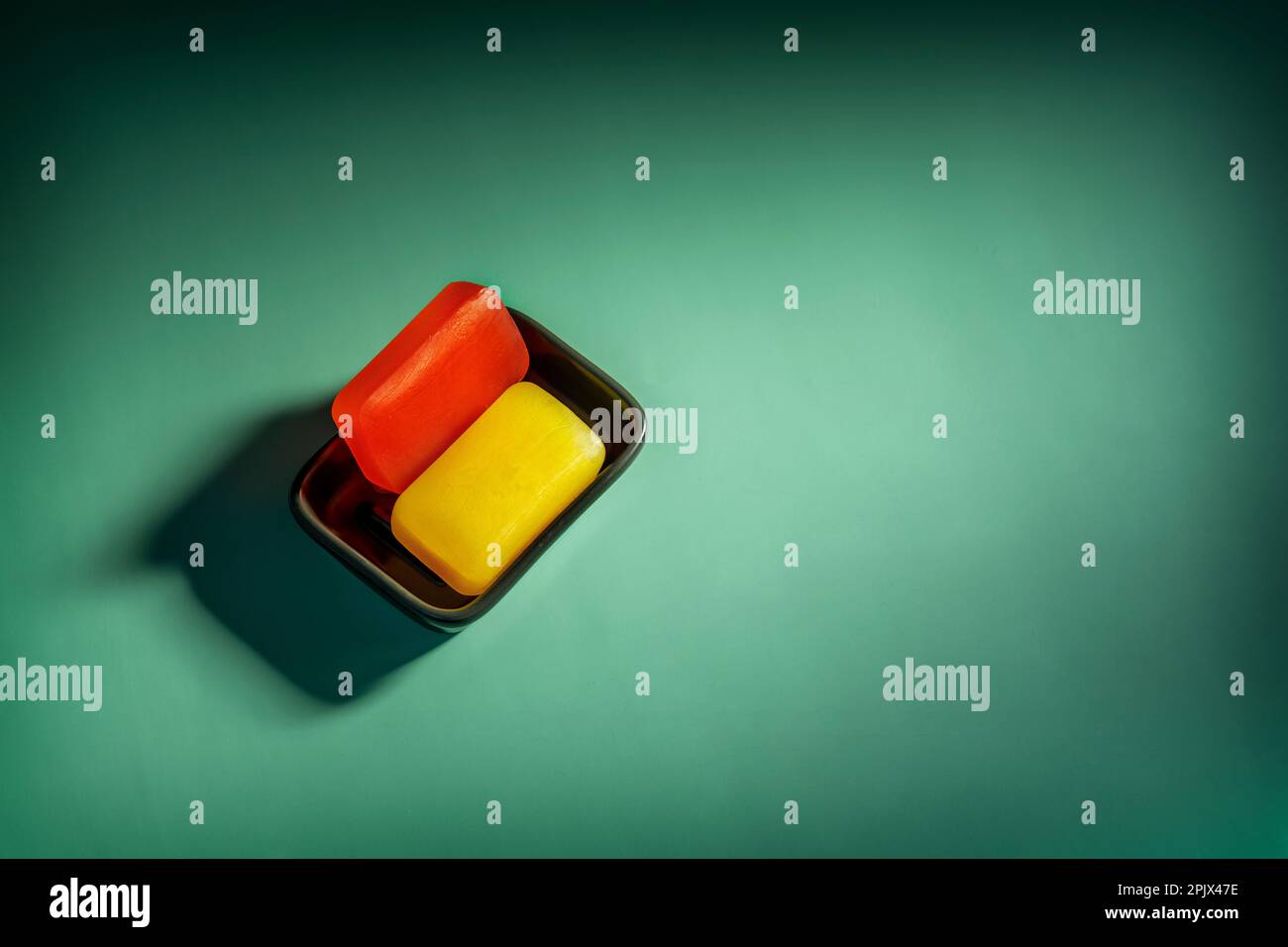 Two colored paraffin soap bars on a smooth green surface Stock Photo ...