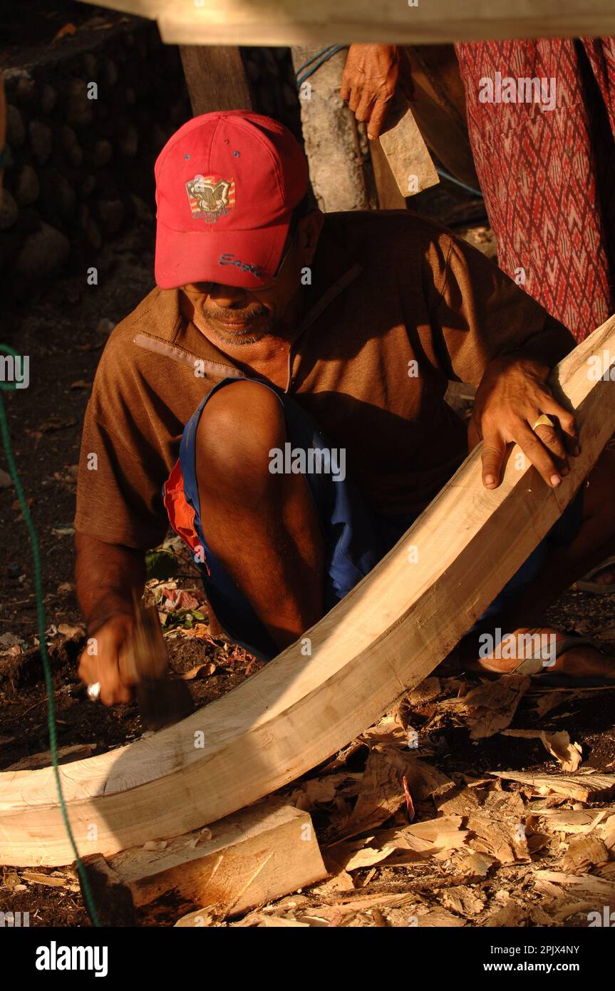 A carpenter boat builder in the fishing village of Kusamba in East Bali ...