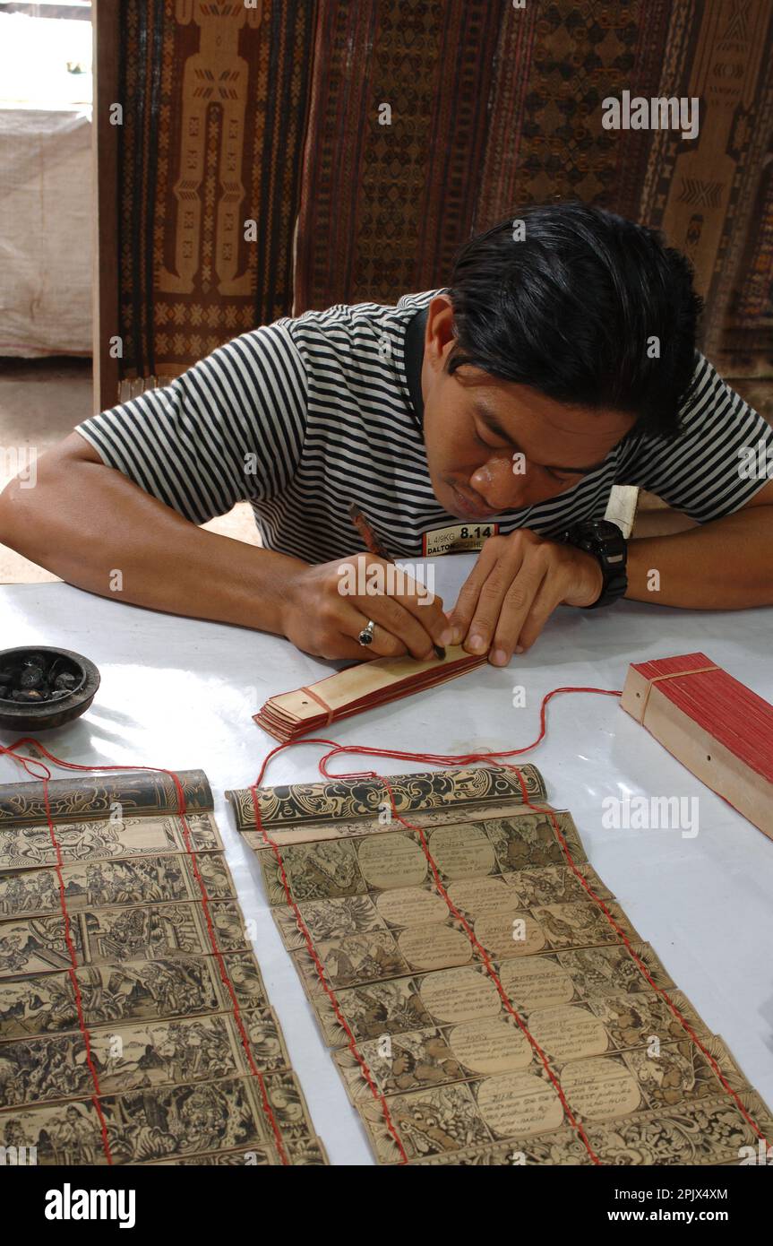 Traditional calligraphy on dried palm leaf at Tenganan village in East ...