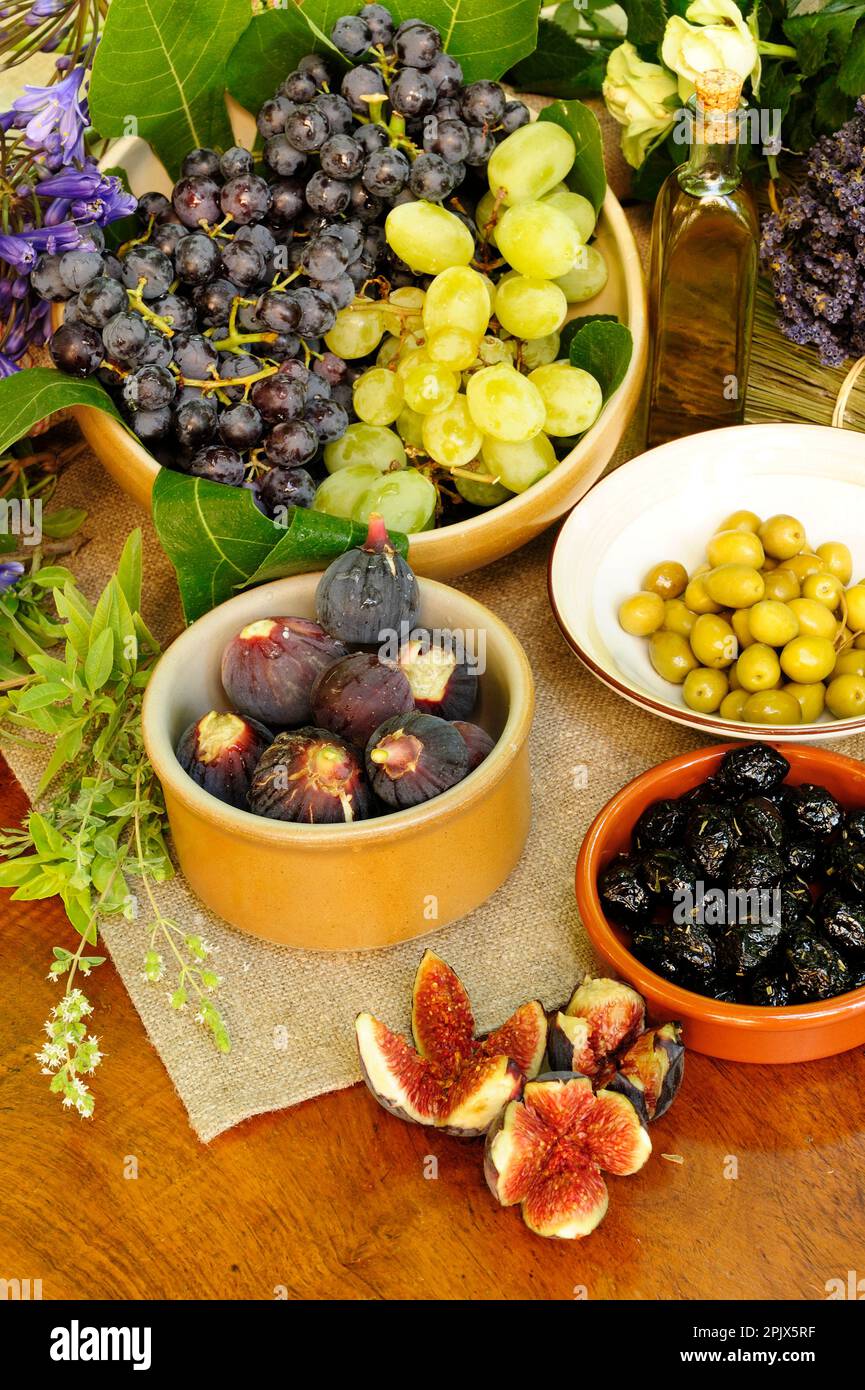 Table of produce from the Provence garden with olives, figs, grapes and ...