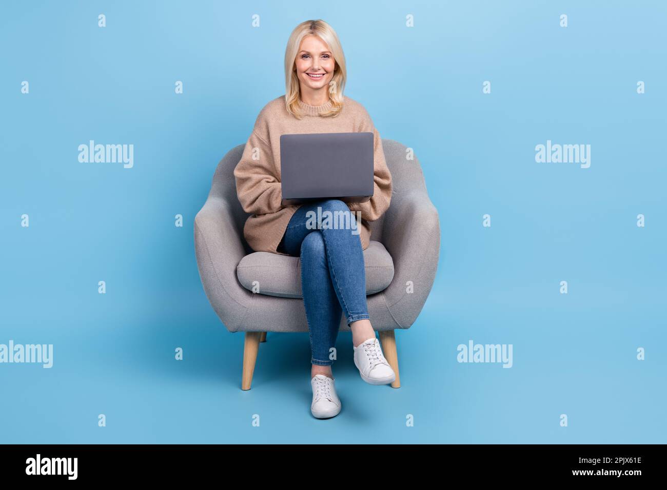 Full body photo of cheerful lady sit chair use wireless netbook ...
