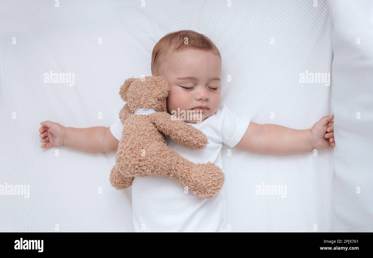 Cute little baby boy slipping Stock Photo - Alamy