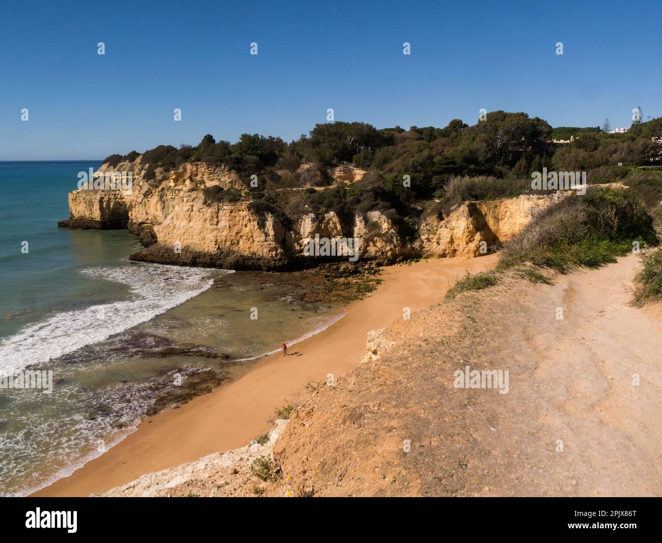 View down to quiet Praia dos Beijinhos beach from coastal path above ...