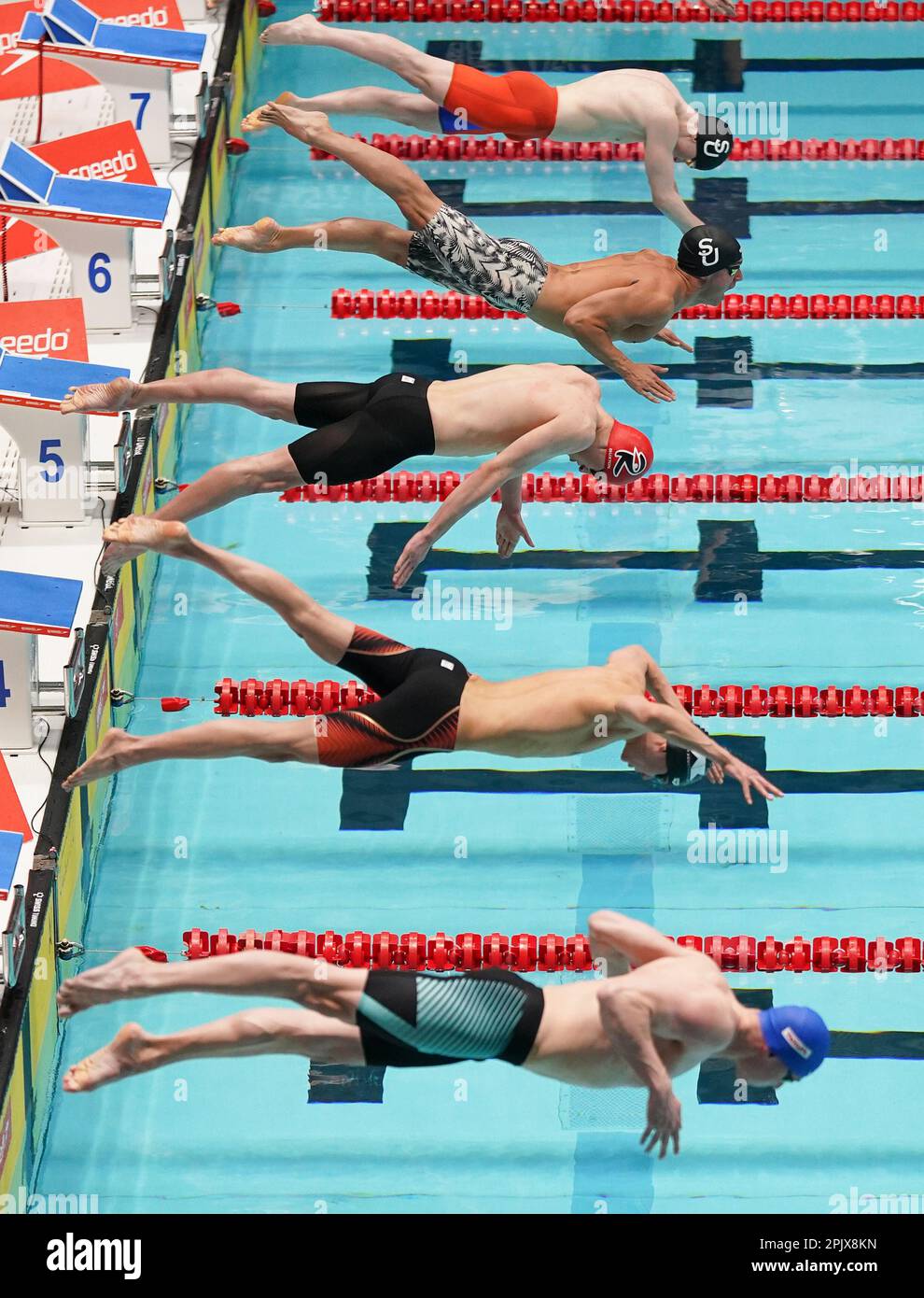 Swimmers in the Men's 100m breaststroke heat A dive into the pool on ...