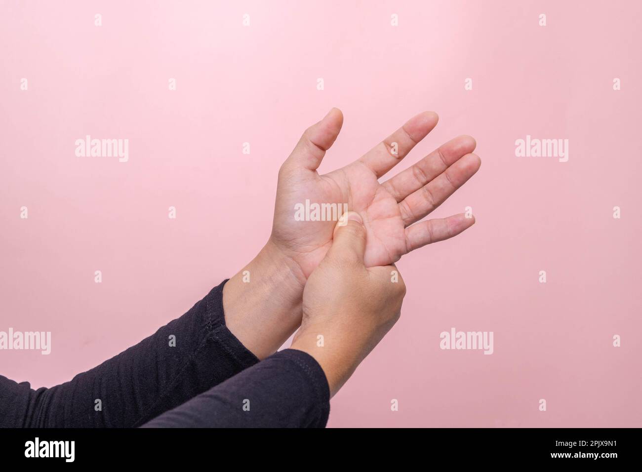 Close-up of woman's hand holding her painful hand suffering from office ...