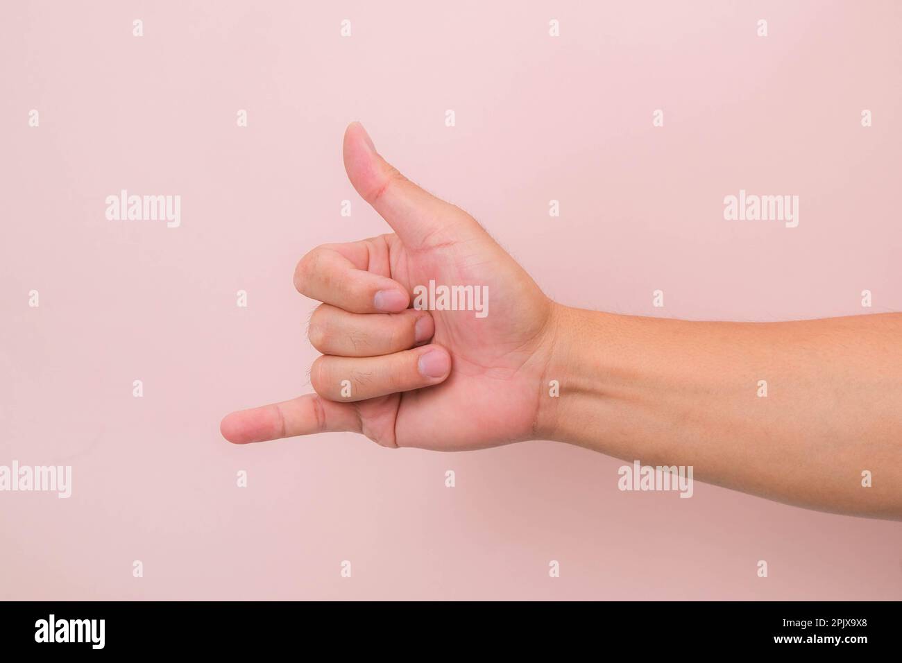 Call me hand sign or gesture isolated on pink background Stock Photo ...