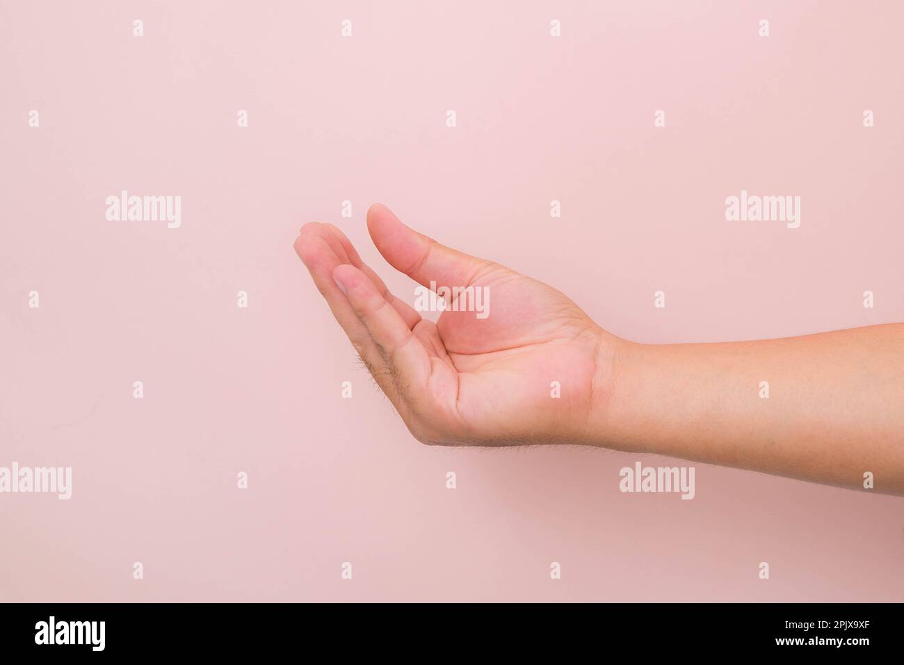 Hands gesture like picking up something isolated on pink background ...