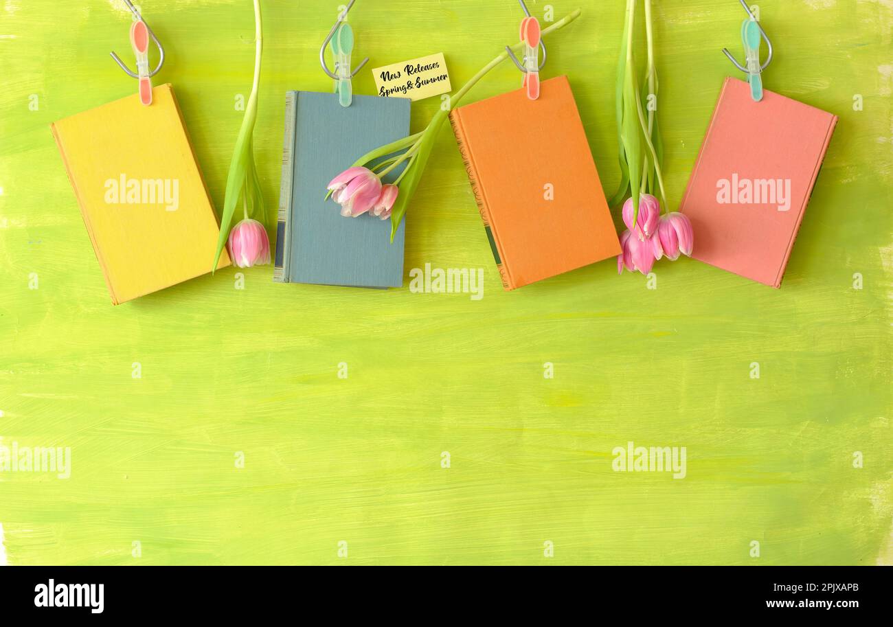 New book releases for spring 2023, with books, tulips and small sign ...