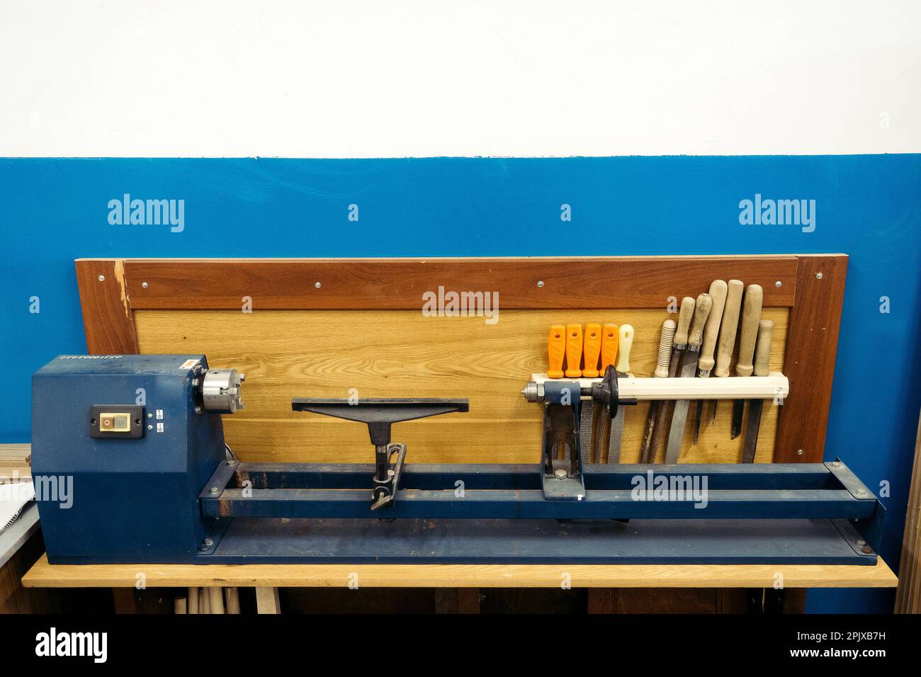 Wood lathe stands in carpentry shop. Background. Milling machine with ...