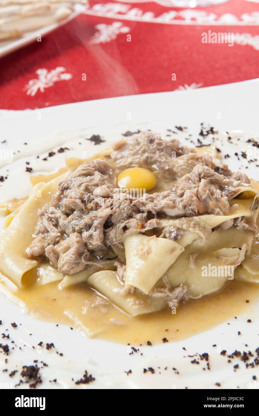 Fresh pappardelle type pasta with quail ragu with its soft egg and ...