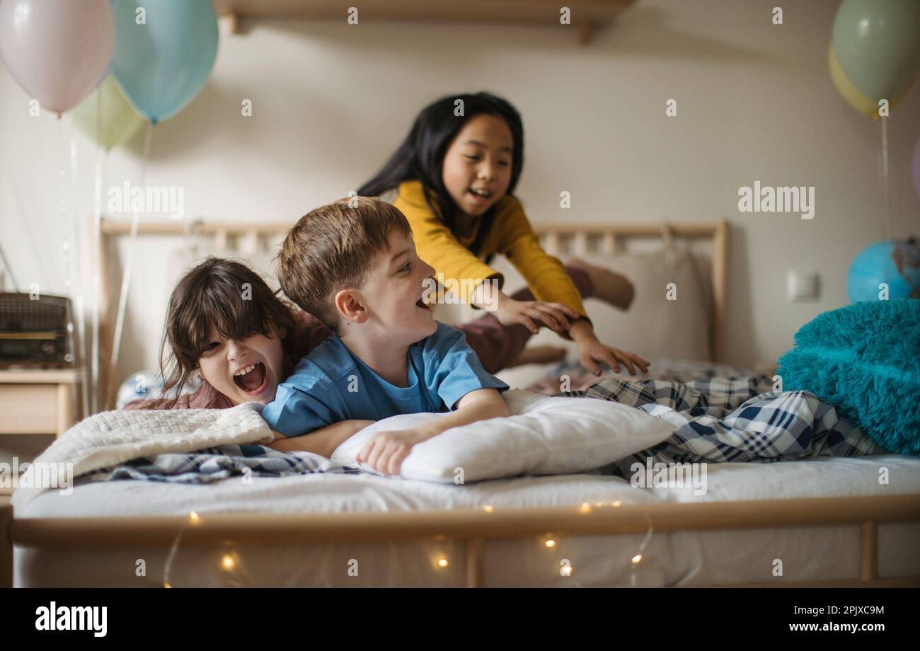 Three happy friends having fun together in a room Stock Photo - Alamy