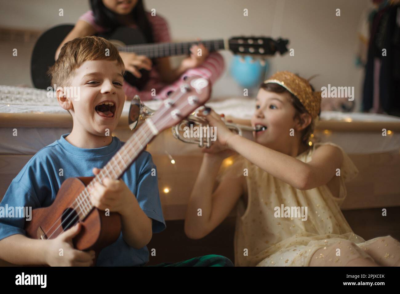 Happy three friends playing on a musical instuments Stock Photo - Alamy